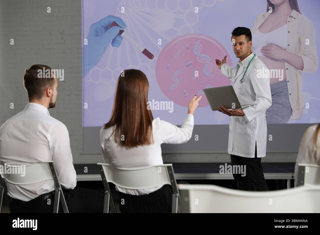 Healthcare professional giving lecture about genetics in conference ...