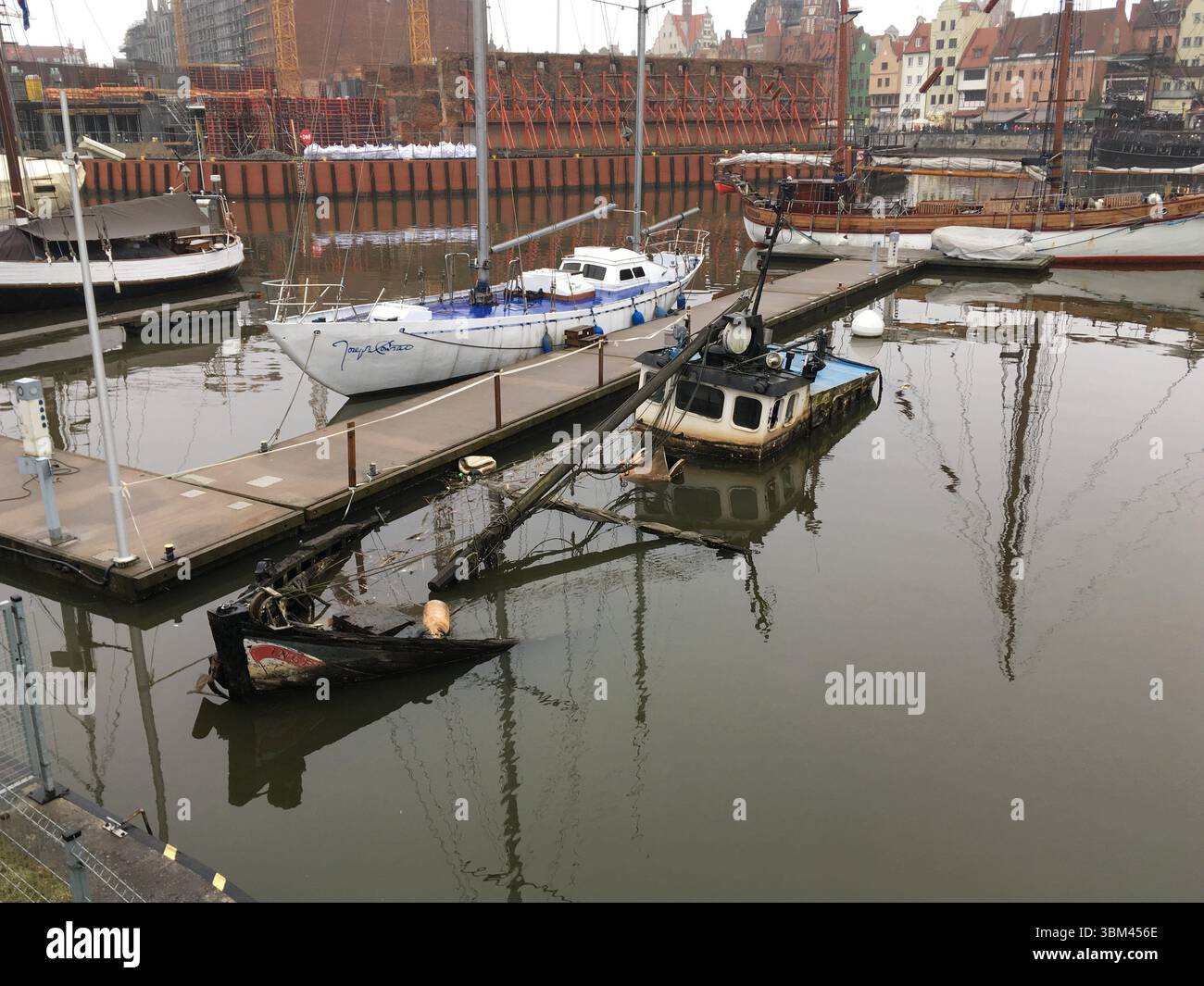 A partially sunken fishing trawler lies in Gdańsk’s Old Town marina on ...