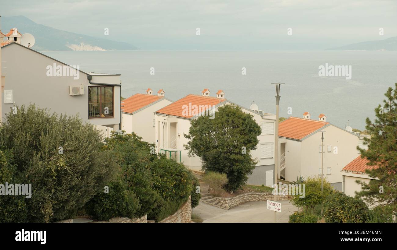 A quiet seaside neighborhood perches on a gentle slope above the ...