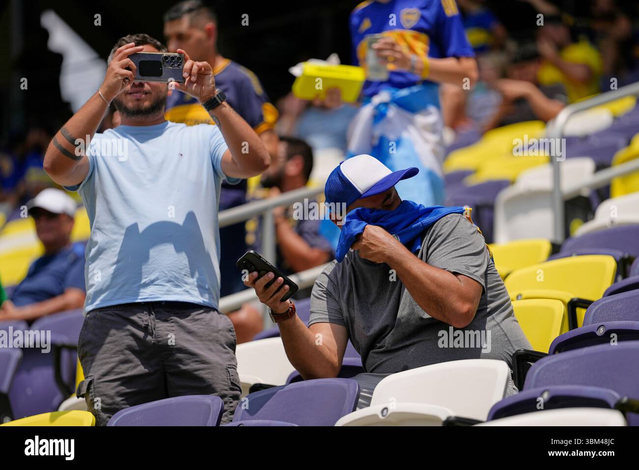 A fan wipes his face before the Club World Cup Group C soccer match ...