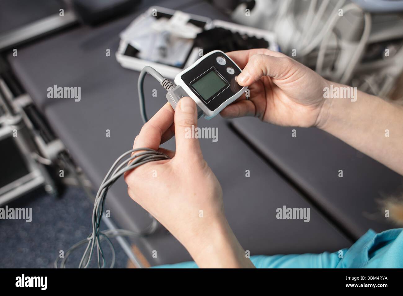 Doctor showing ECG holter monitor to patient in pediatric clinic ...