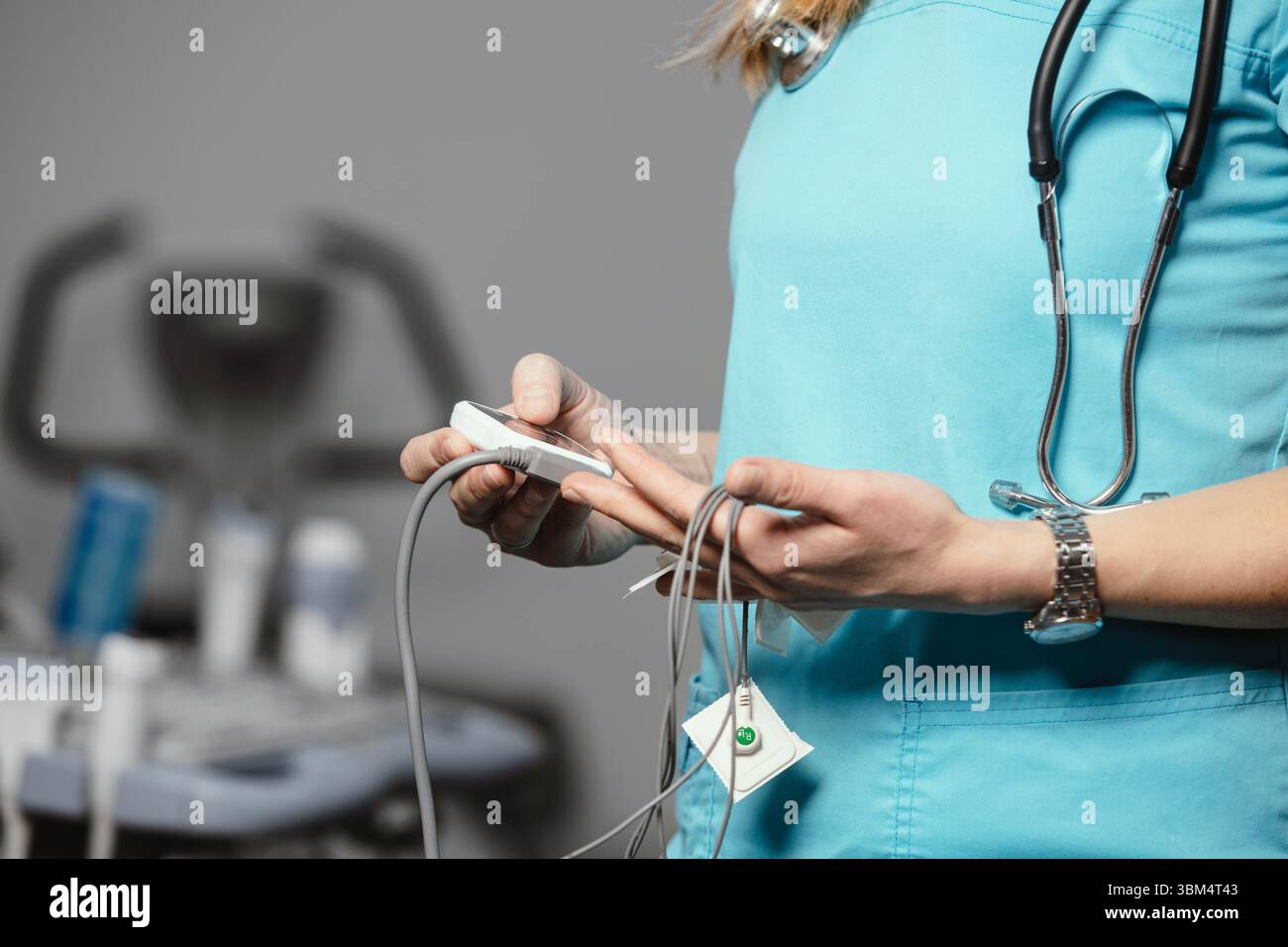Doctor showing ECG holter monitor to patient in pediatric clinic ...