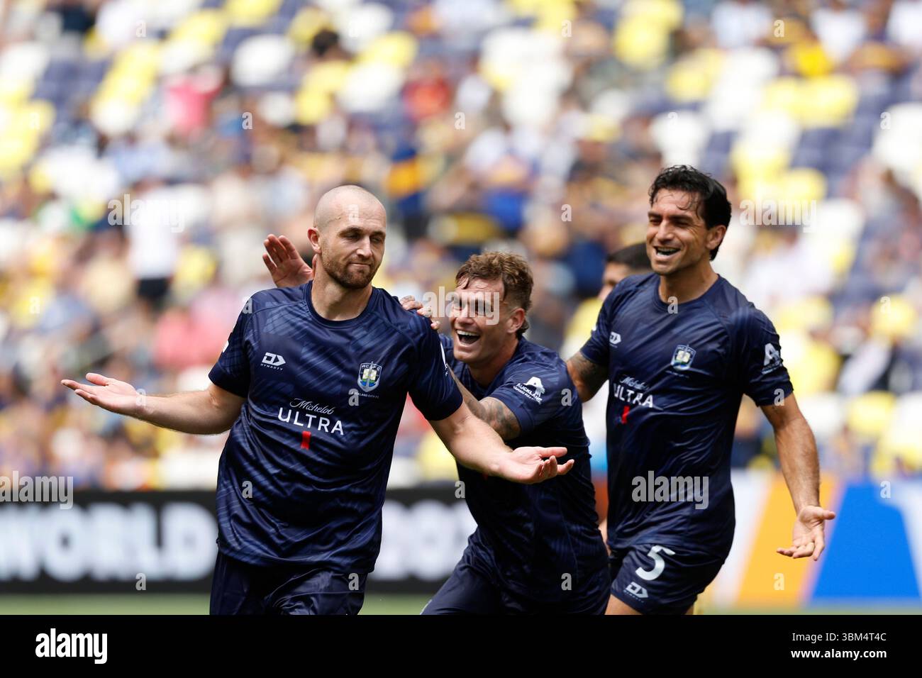 Auckland City's Christian Gray, left, celebrates after scoring his side ...