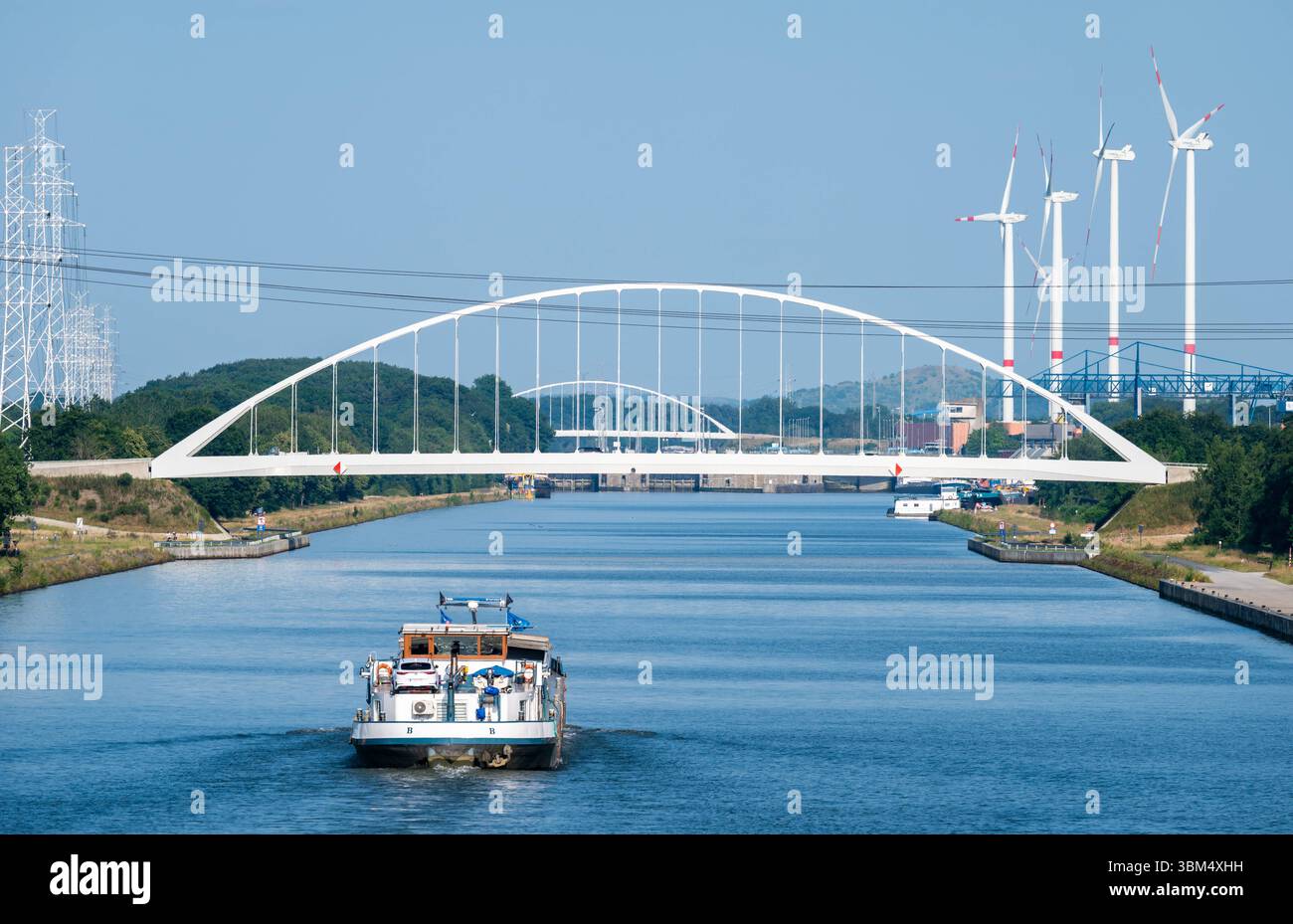 Bridge view over the Albert canal with industry and windmills for ...
