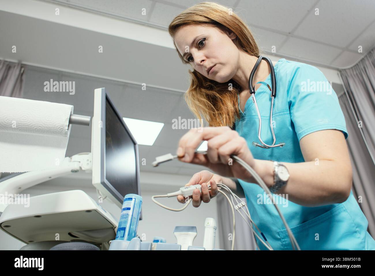 A cardiologist is doing a procedure to check the heart. Cardiologist ...