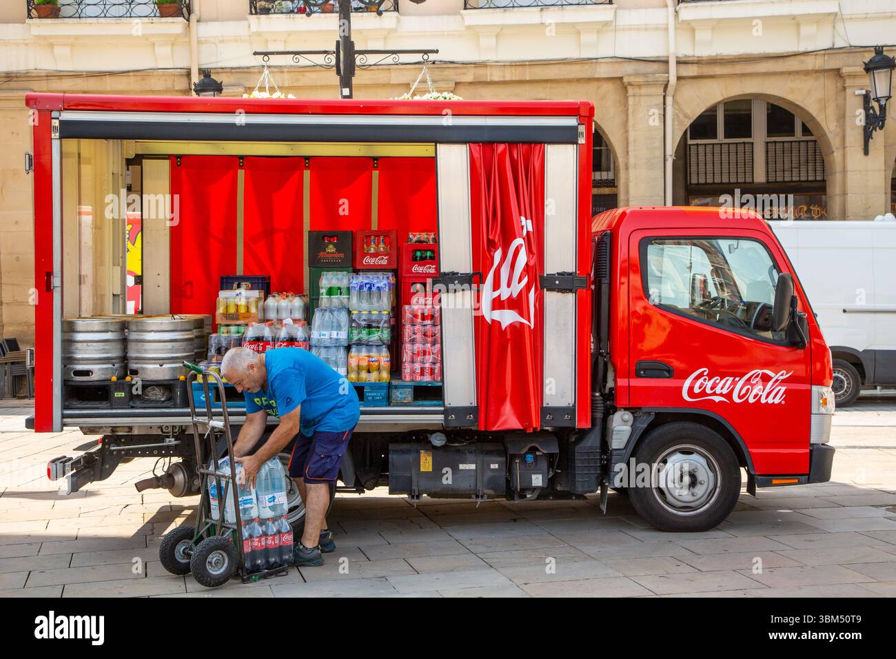 Coca Cola truck driver making a delivery in the town of Logrono Spain ...