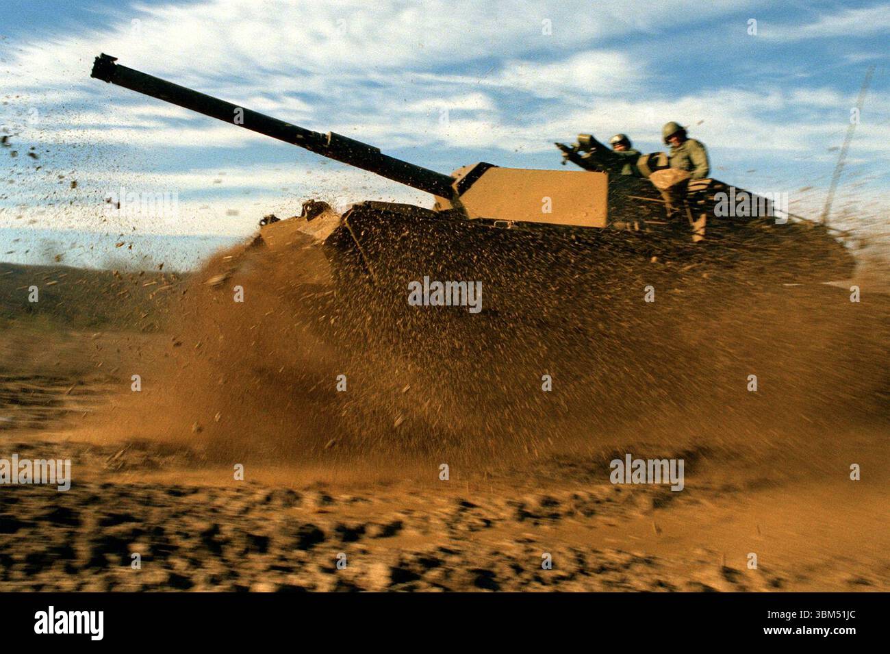 Left side view of the XM1 Abrams tank rolling over muddy ground Ft Knox ...