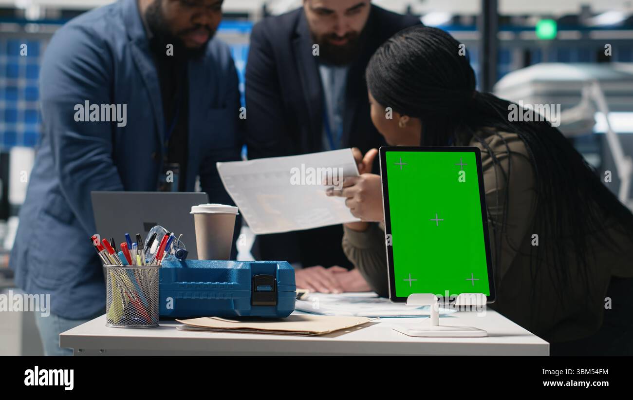 Team of consultants and experts working with a chroma key screen in the ...
