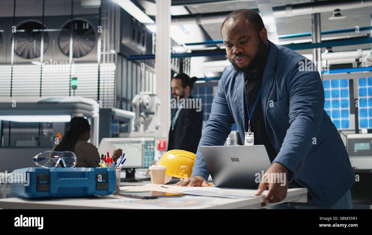 Black industrial expert reviewing high hi-res stock photography and ...