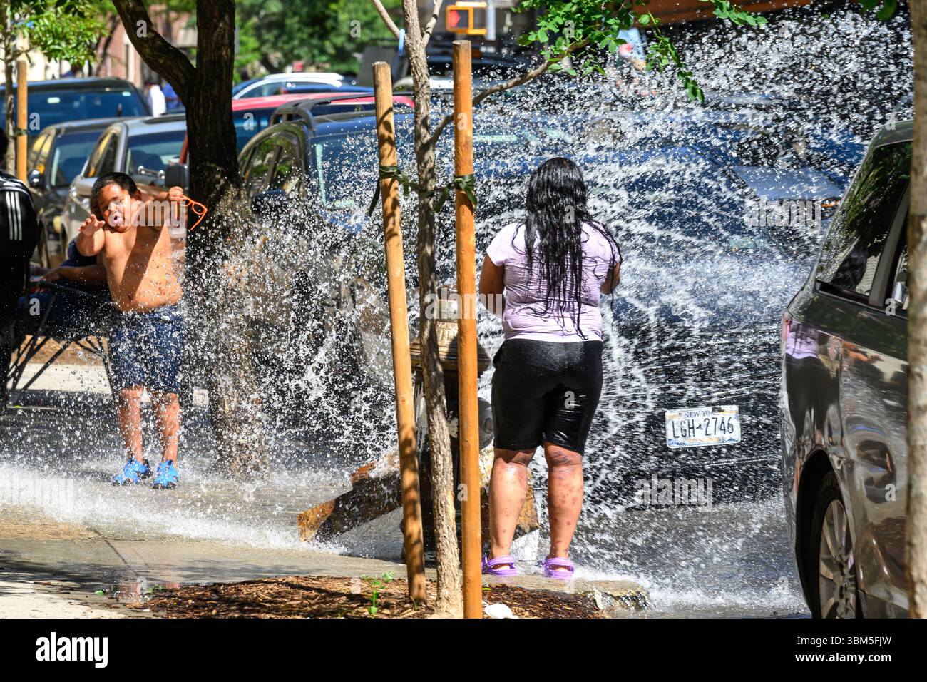 New York, USA. 24th June, 2025. Children play with a water spray from ...