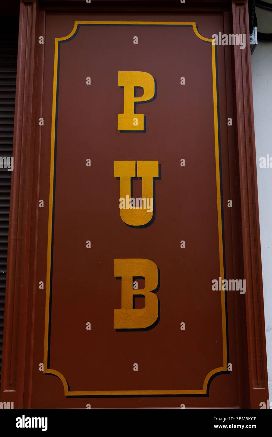 This image showcases a prominent pub sign with the word 'PUB' painted ...