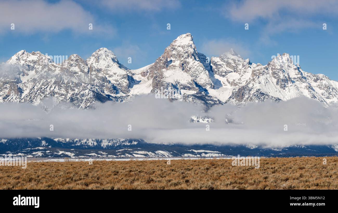 USA, Wyoming, Jackson. Grand Teton National Park, Fog hovers beneath ...