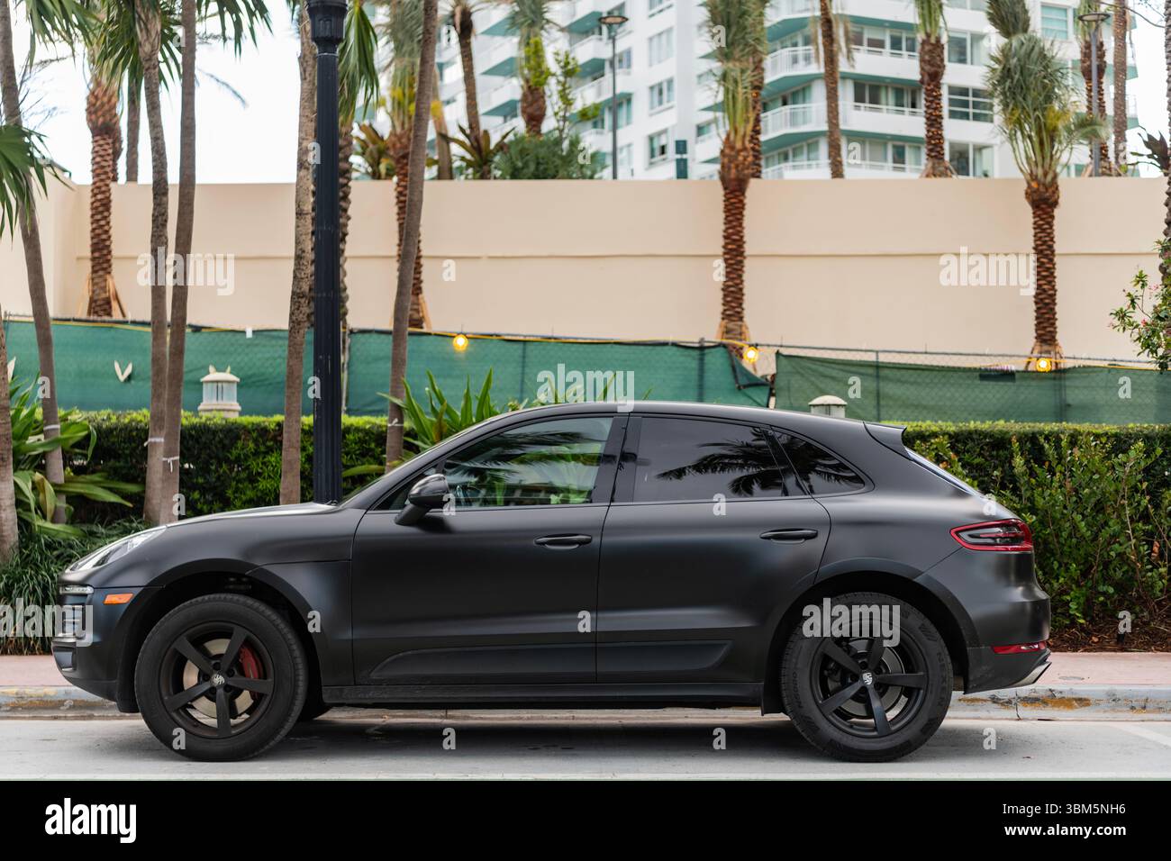 Miami, Florida, USA - April 02, 2025: Black matte car, side view ...
