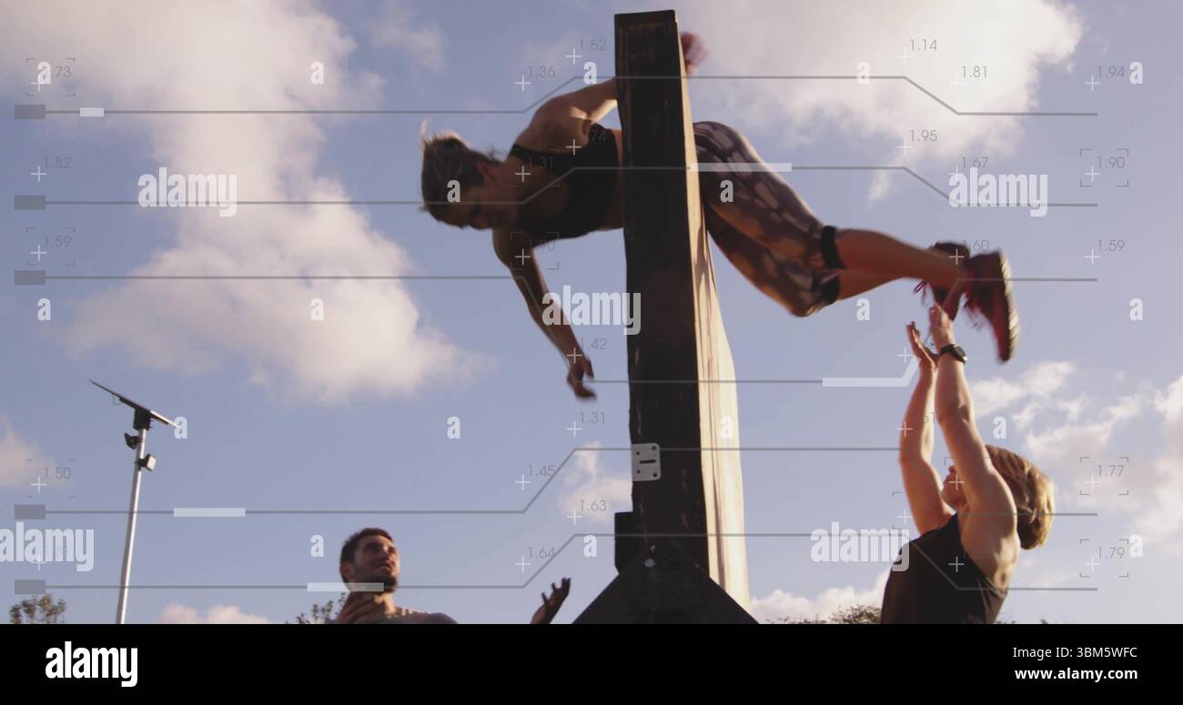 Vaulting female athlete overcoming tall wooden wall at outdoor training ...