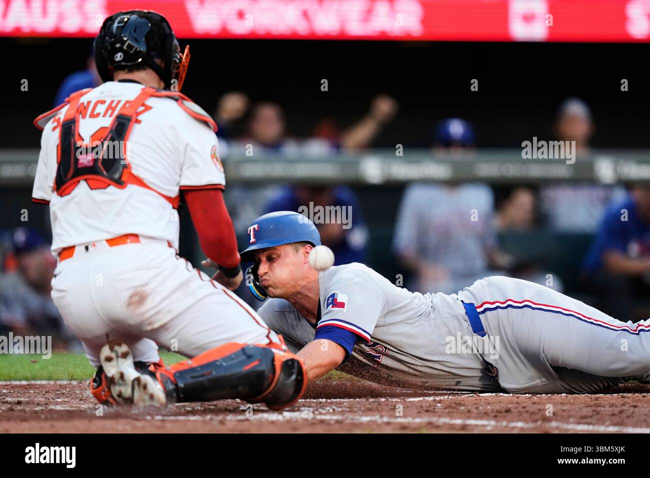 Texas Rangers' Corey Seager, right, scores past Baltimore Orioles ...