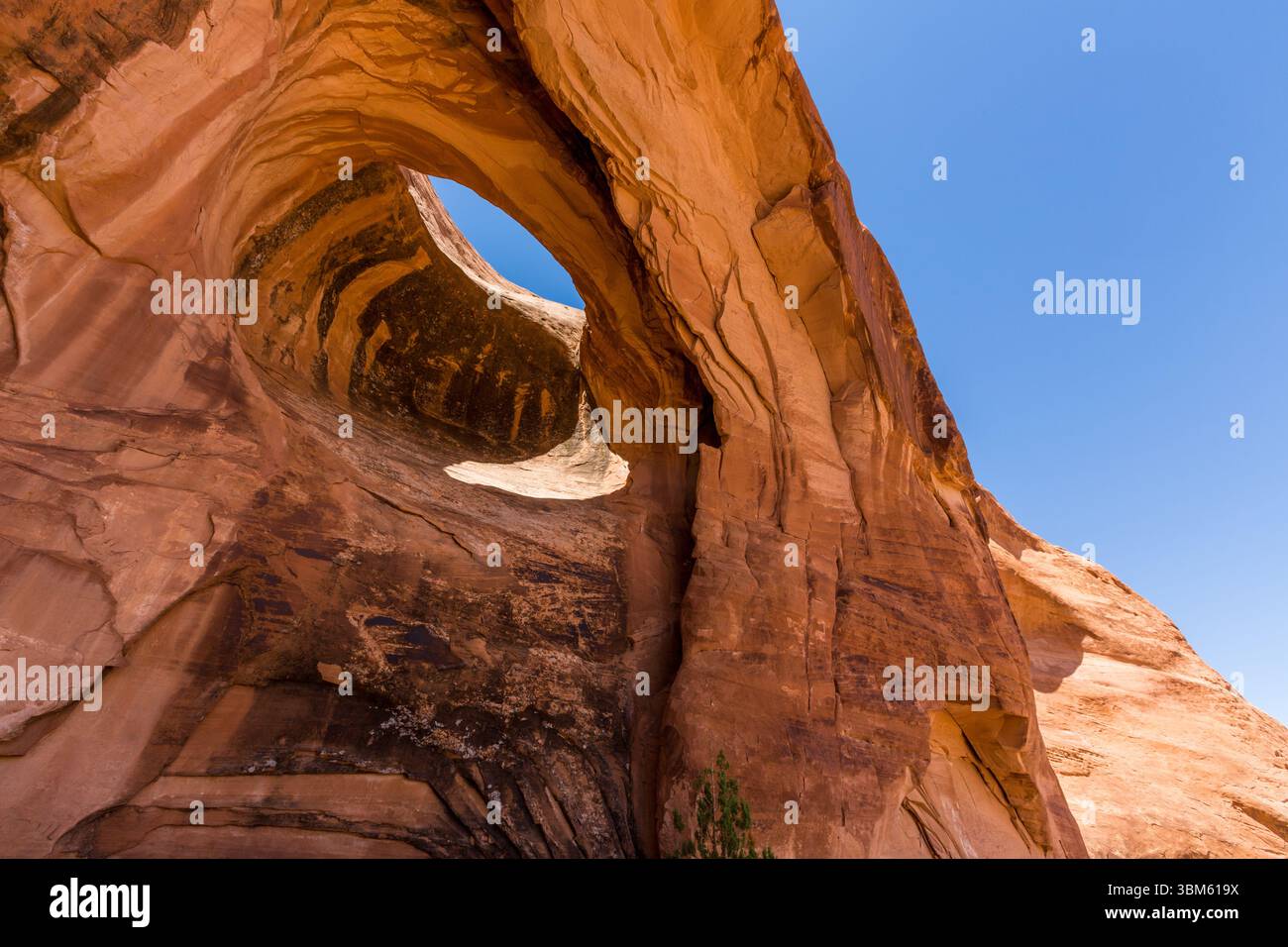 Cummings Arch is a pothole arch south of Moab, Utah, USA. A pothole ...