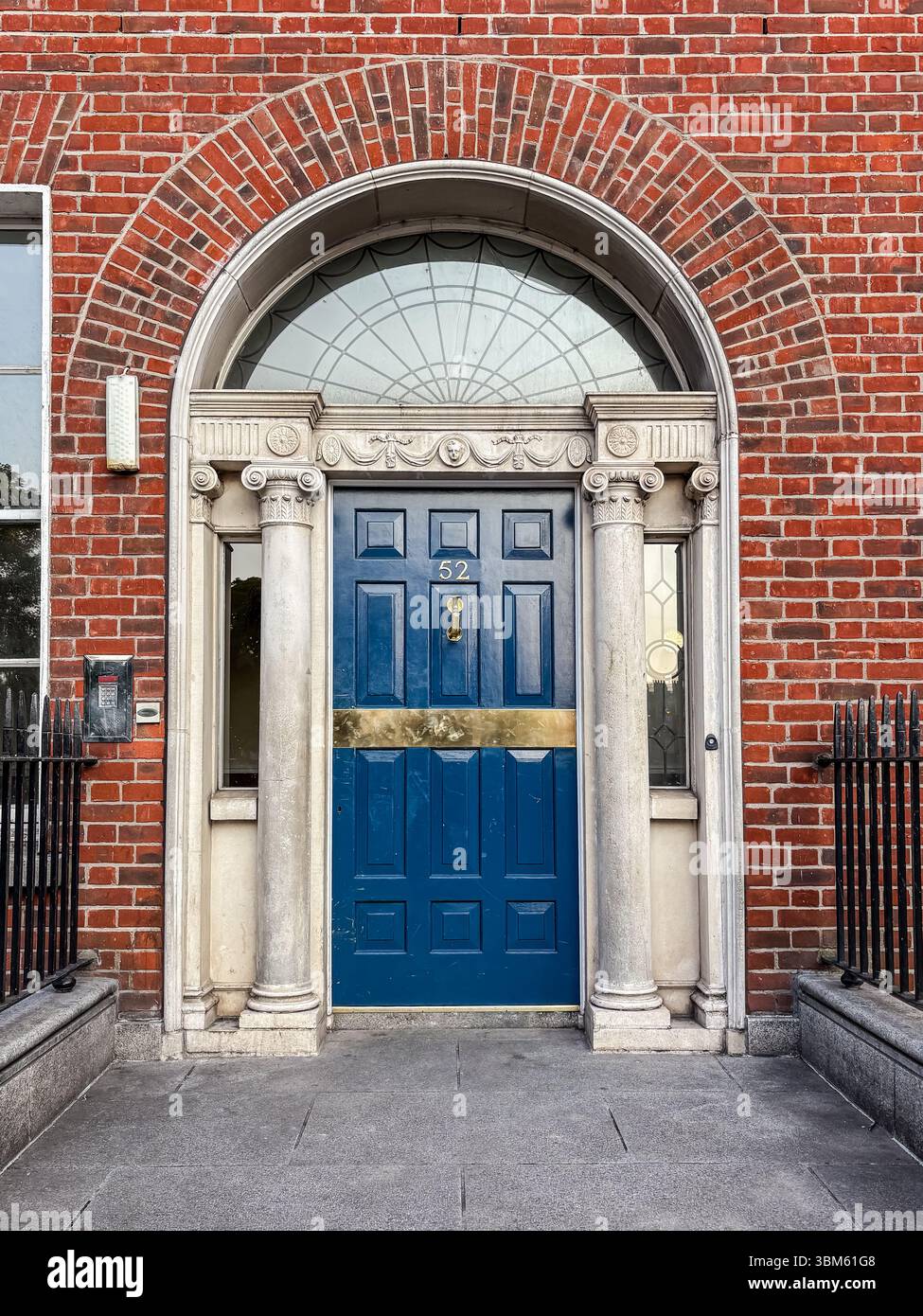 Georgian door. Typical entrance with columns, fanlight, blue paneled ...
