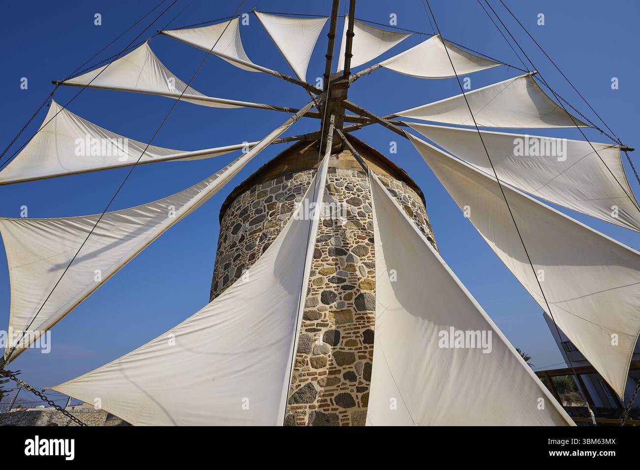 Wide sails on a stone windmill, blue sky in the background, windmill ...