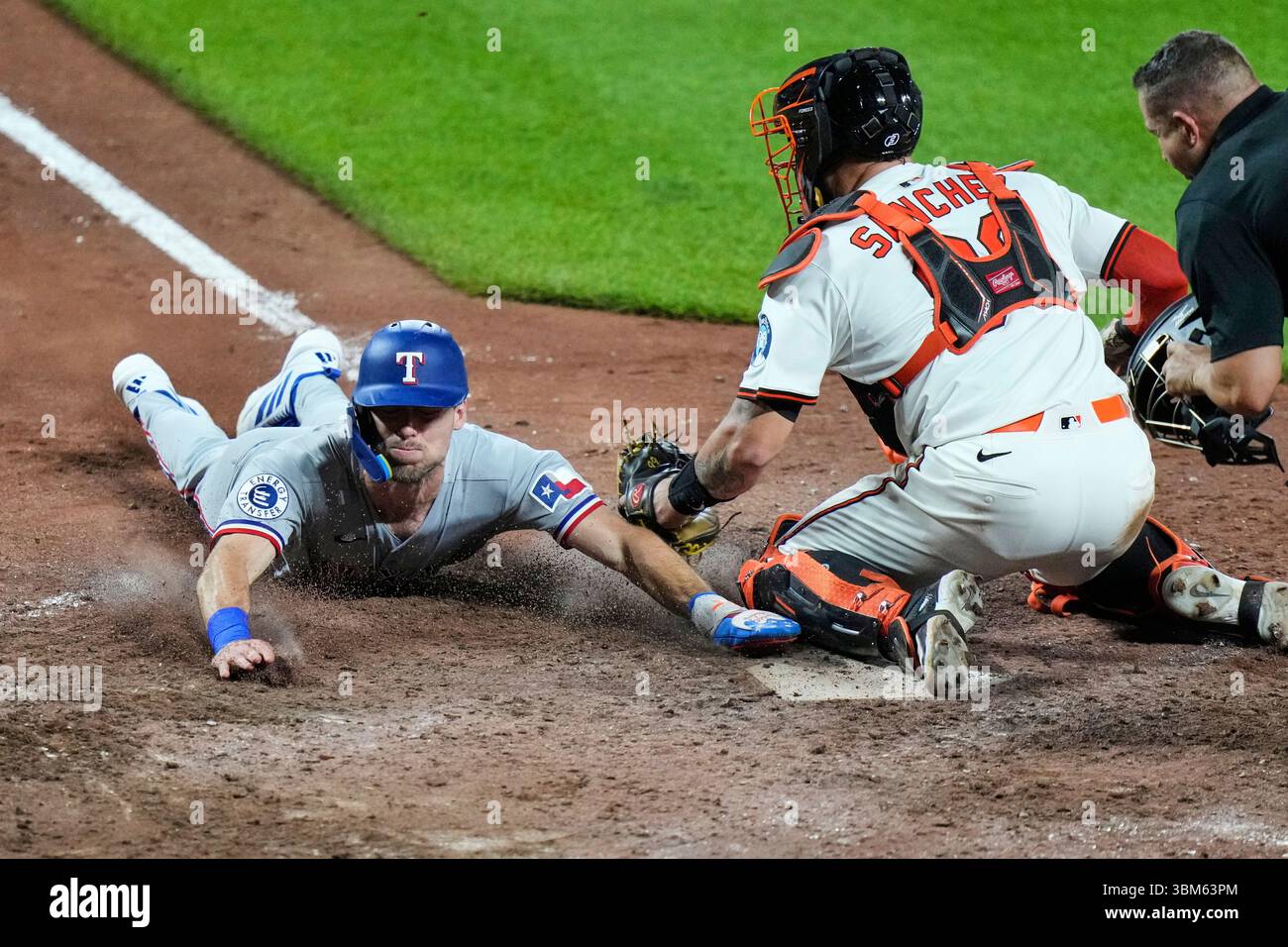 Texas Rangers' Evan Carter, left, scores past Baltimore Orioles catcher ...