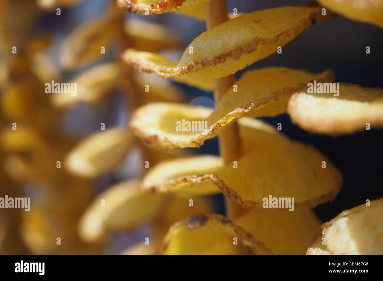 Twisted potato chips arranged on a display stand Stock Photo - Alamy