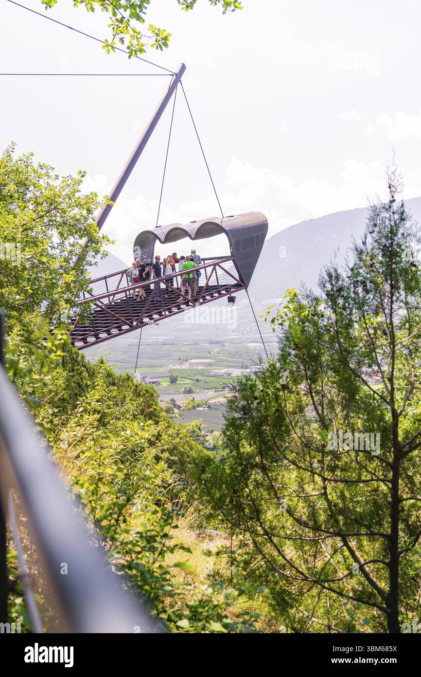 People on a floating platform in a mountainous landscape with green ...