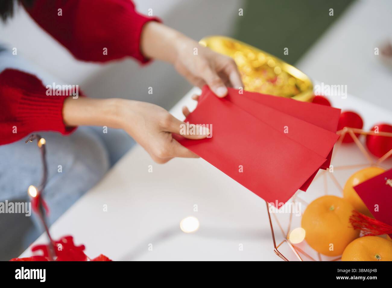 Asian Woman giving red envelope for Lunar New Year celebrations. Hand ...