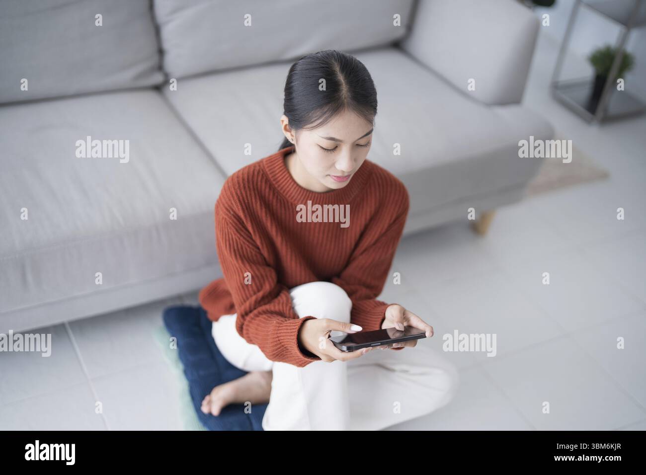 Asian Woman controlling smart home. mobile phone with smart home app in ...