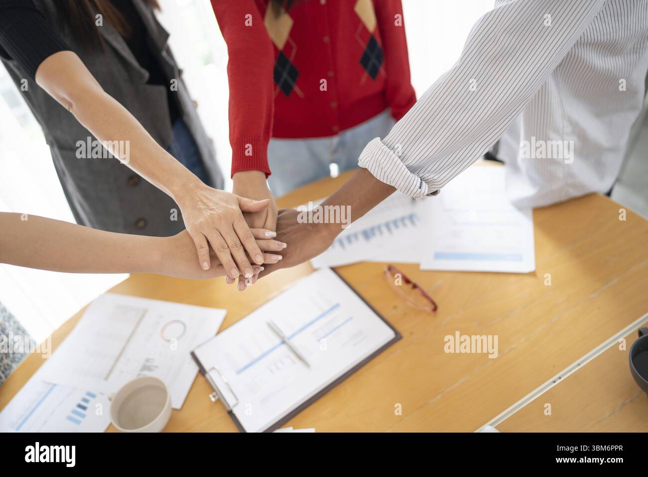 Team building group of people Asian business hands stack unity and ...