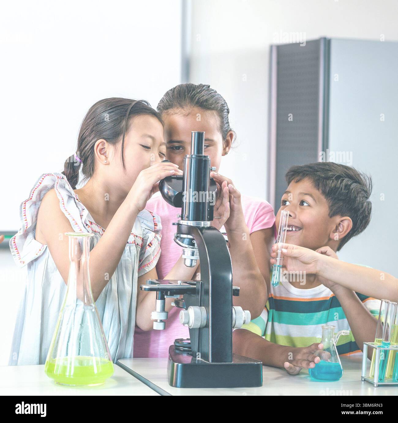 School children in science lab using microscope Stock Photo - Alamy