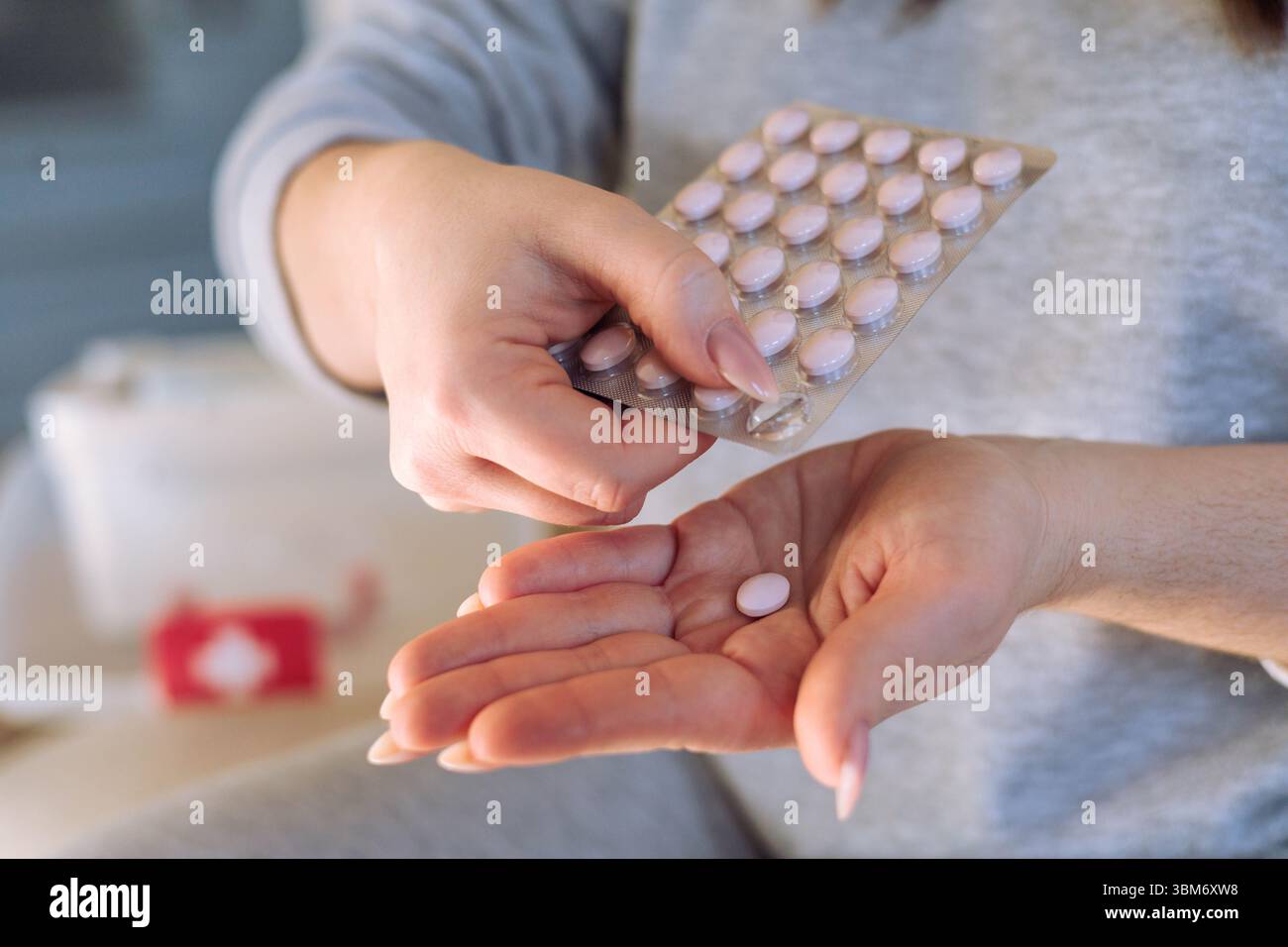 Female hands holding pink round hormonal contraceptive pill Stock Photo ...