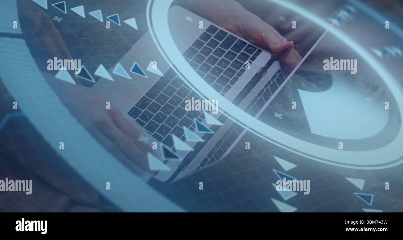 Woman's hands holding smartphone and tapping laptop keyboard at wooden ...