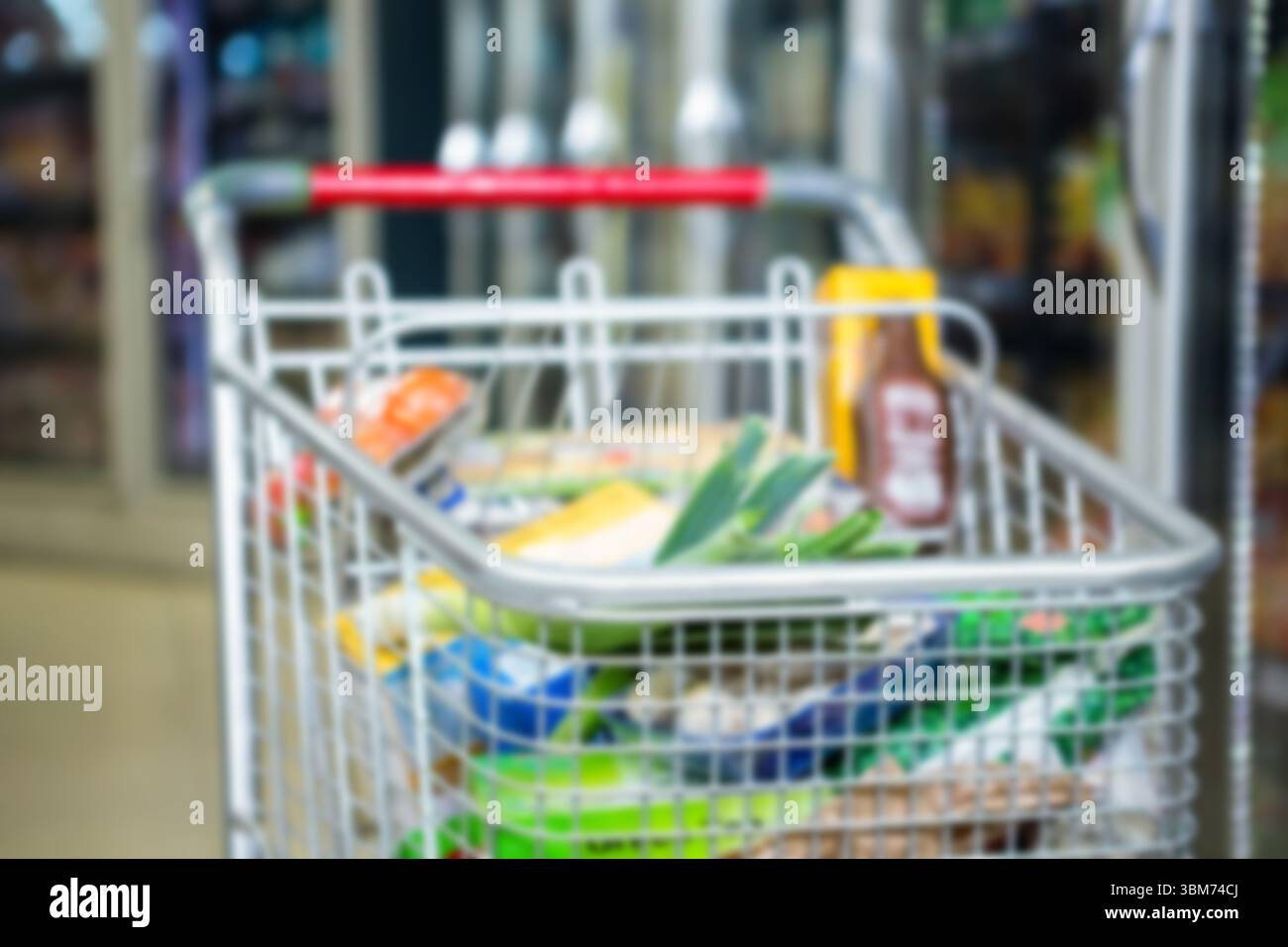 Shopping cart in refrigerated section Stock Photo - Alamy