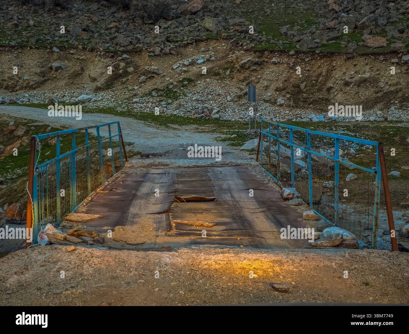 Old single-lane bridge shows signs of deterioration with weathered ...
