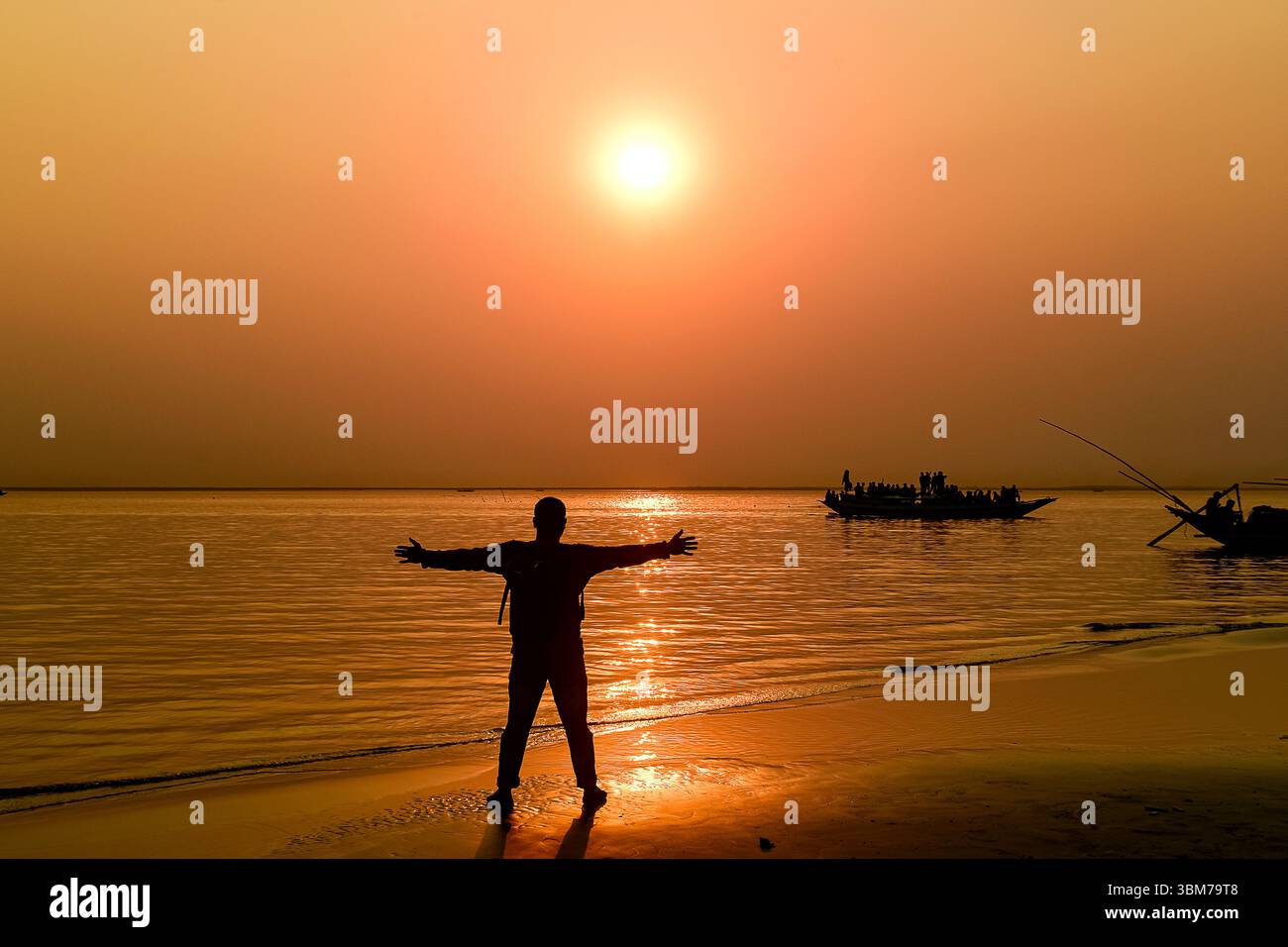 A breathtaking golden sunset over the Padma River at Moinot Ghat in ...