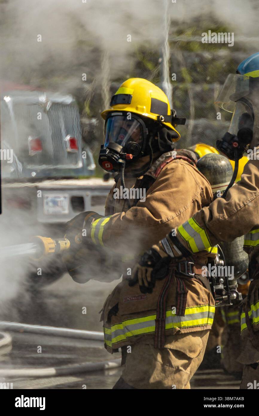 A Firefighter with Marine Corps Installations Pacific, extinguishes an ...