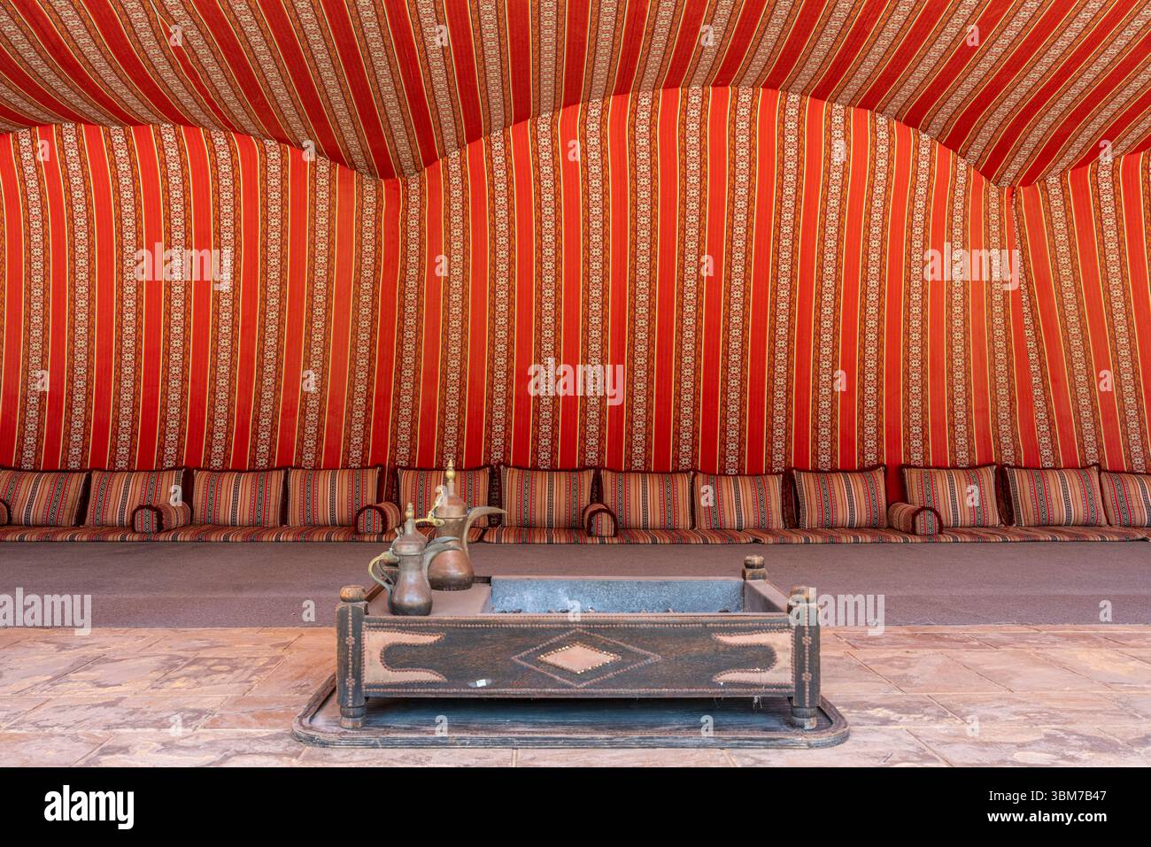 Traditional striped fabric tent interior with Arabic coffee set on a ...
