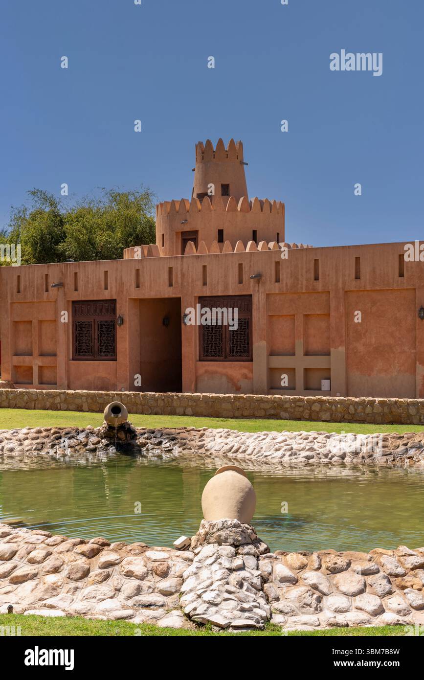 Traditional mud brick fortress with crenellated walls and towers is ...