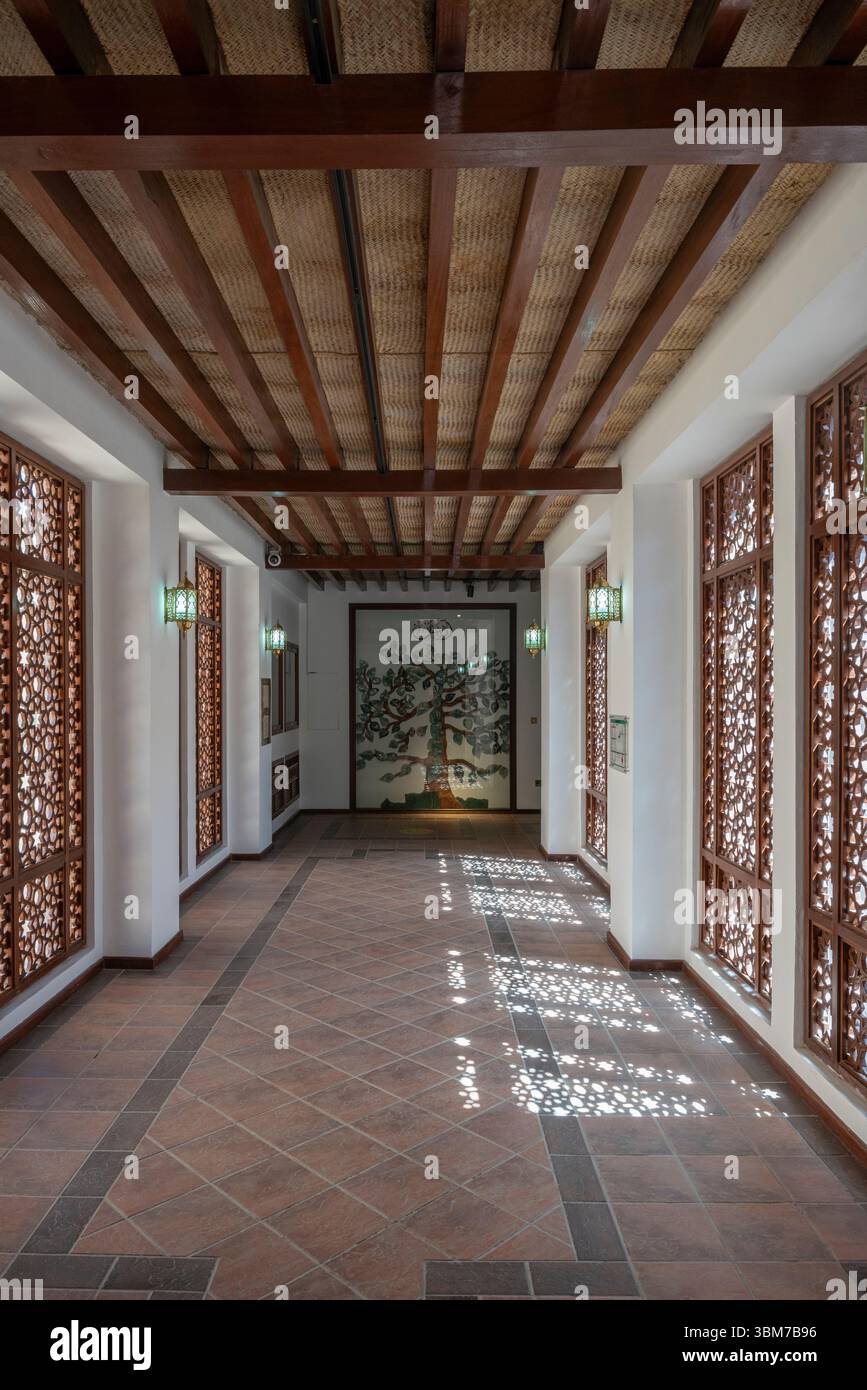 Long corridor with wooden ceiling beams and patterned shadows on the ...