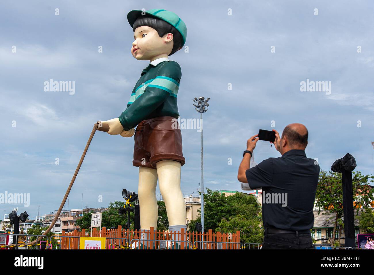 Bangkok, Thailand. 25th June, 2025. A man seen takes a photo of a 12 ...