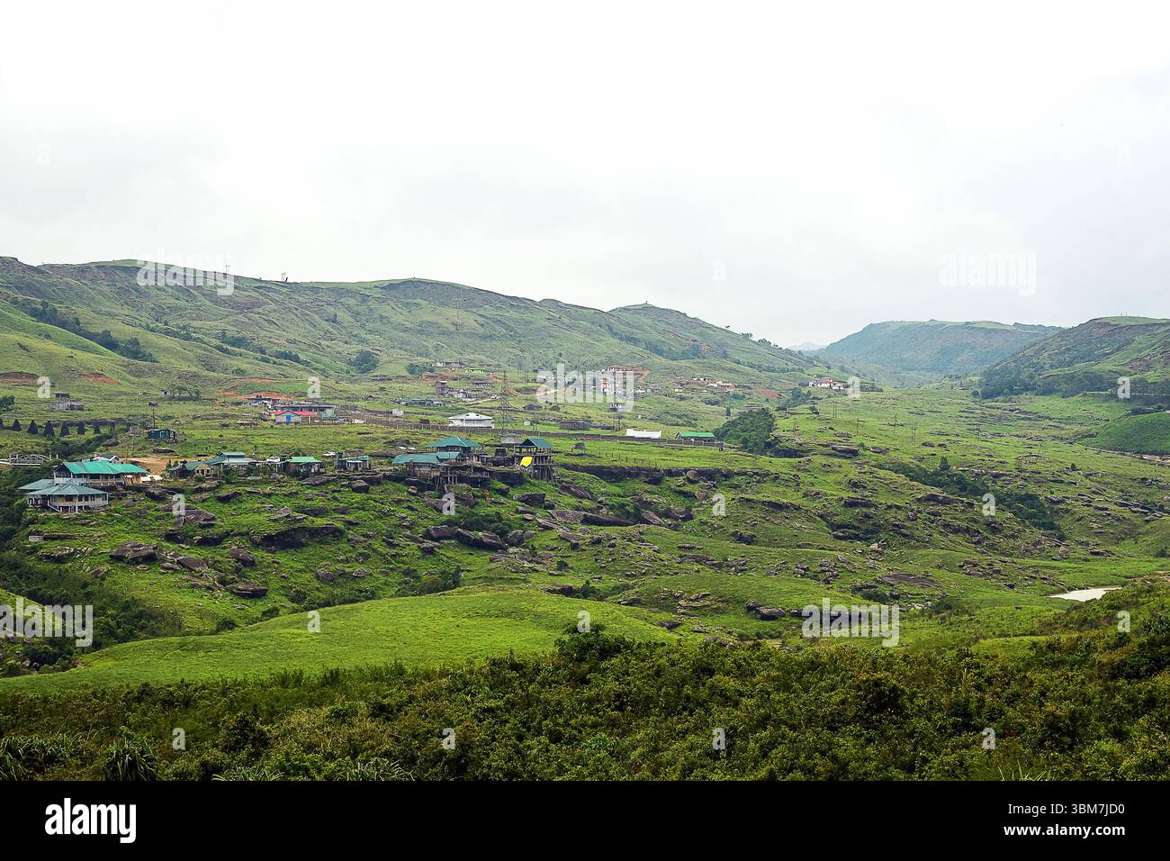 The view captures expansive green hills and valleys dotted with small ...