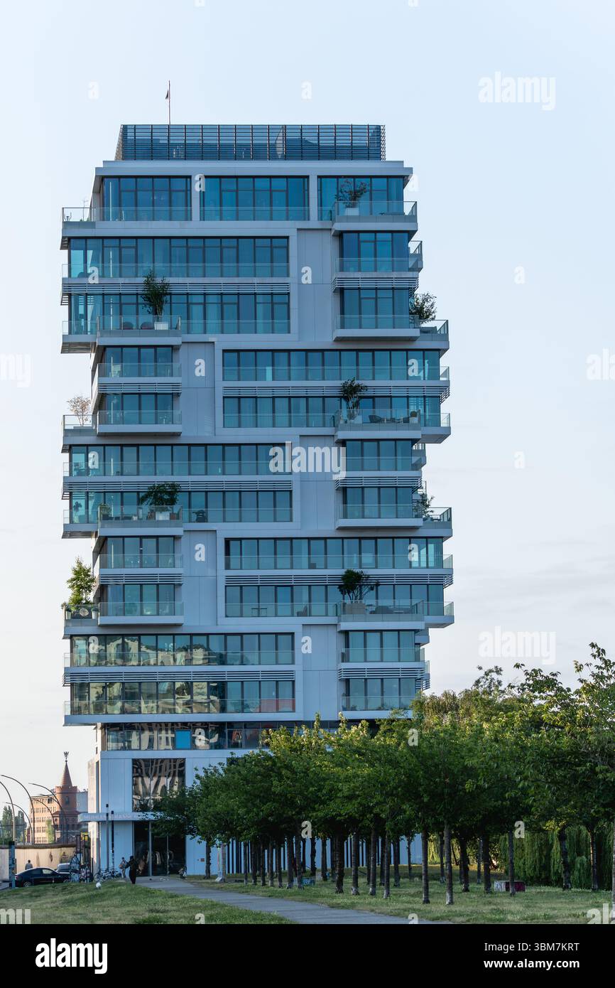 Modern glass apartment tower with staggered balconies and integrated ...