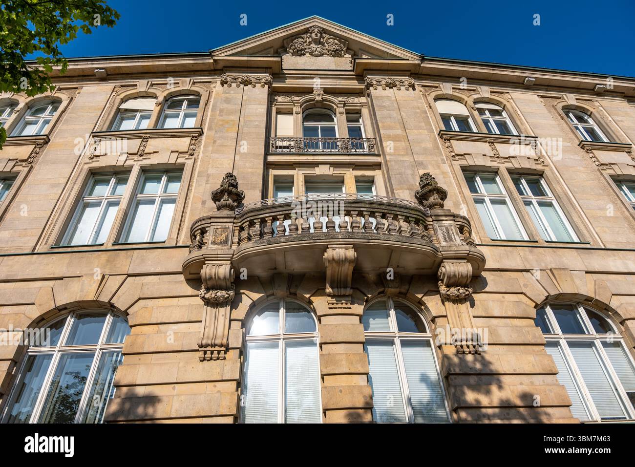 A magnificent old building with a detailed facade, high windows, and a ...
