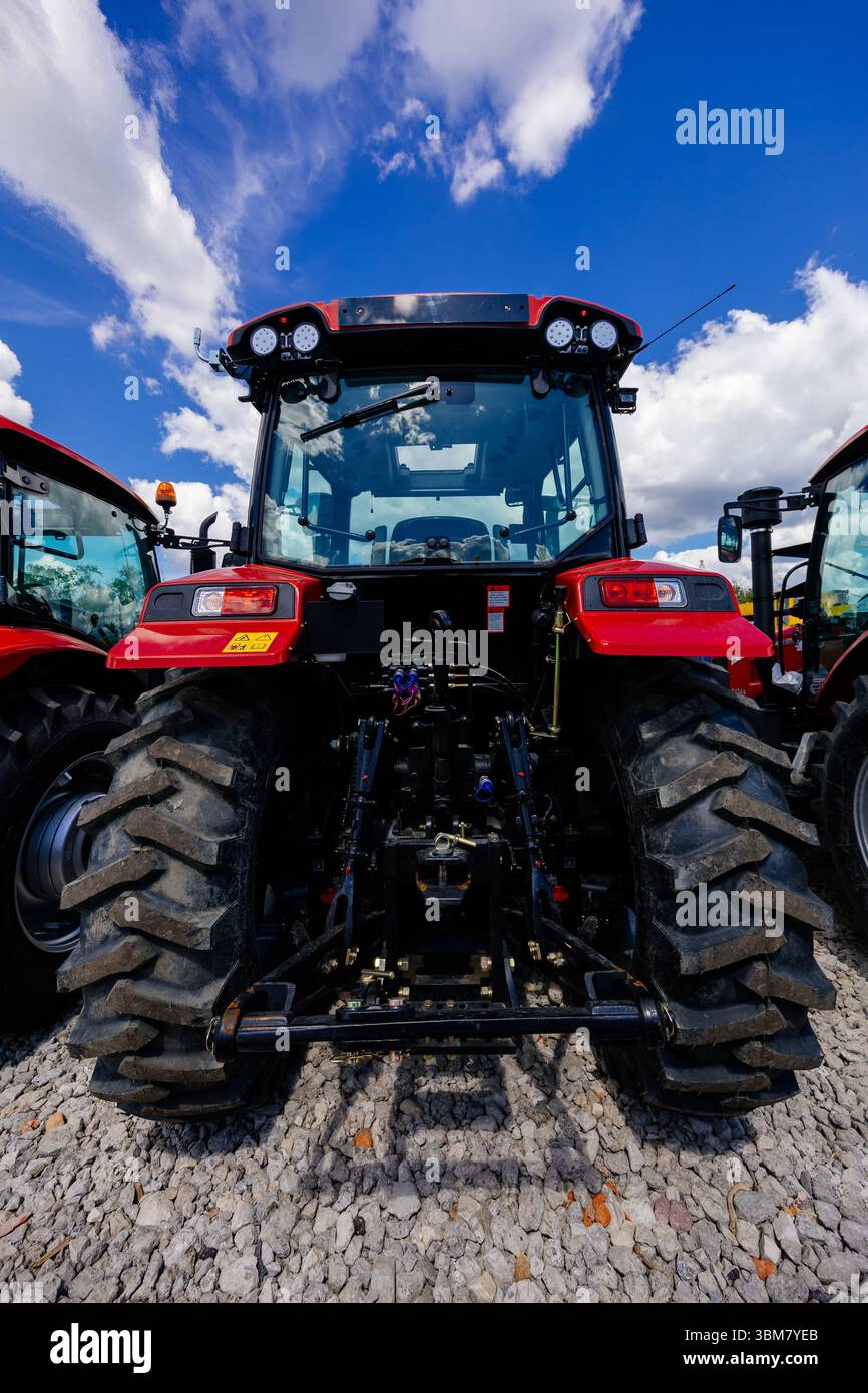 Rear view of modern agricultural tractor in hangar. Hydraulic hitch ...