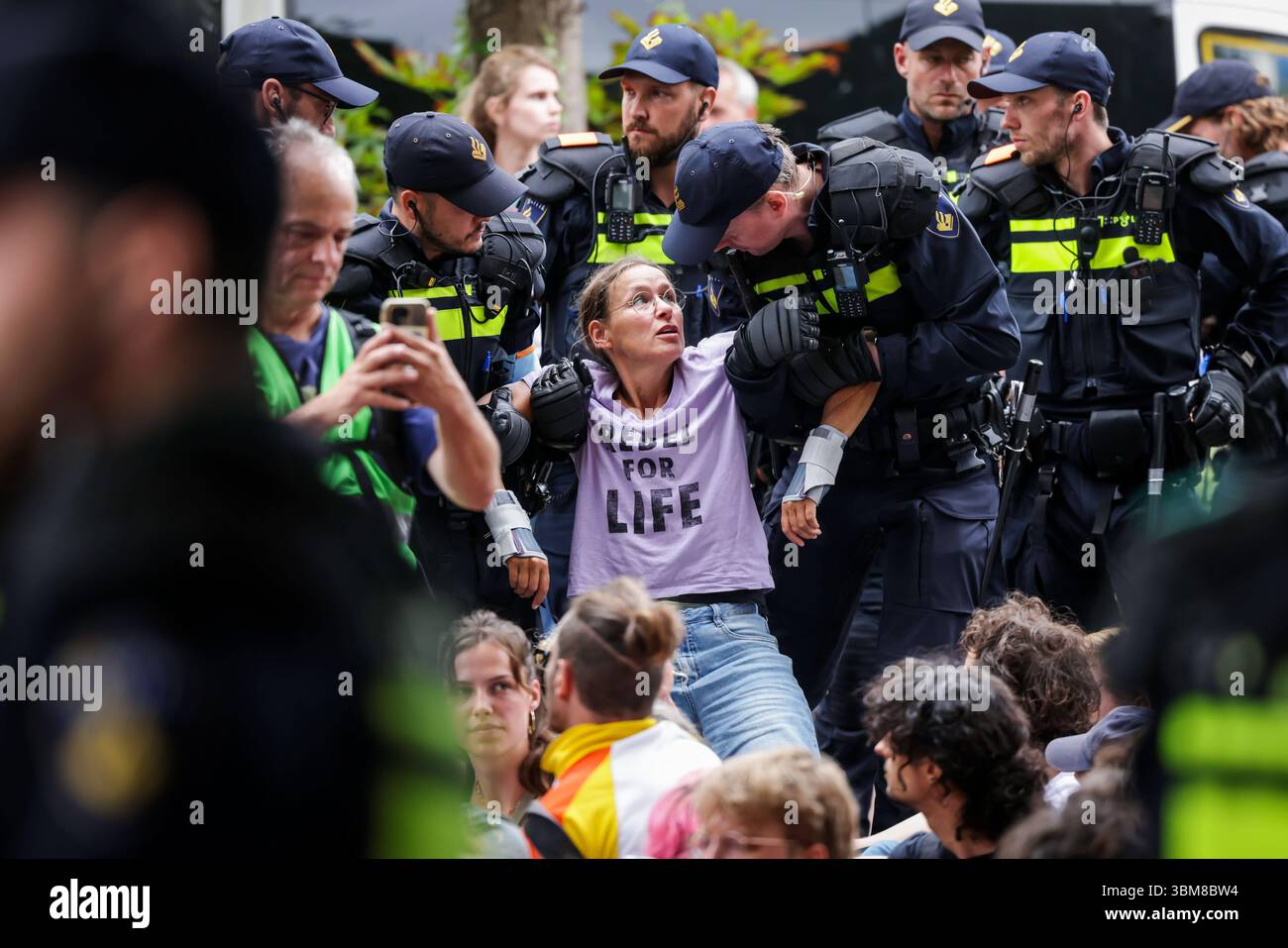 DEN HAAG - A protester from Extinction Rebellion (XR) is taken off the ...