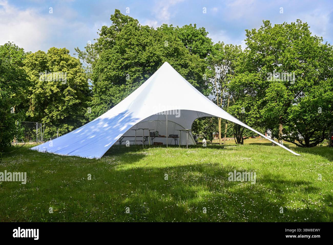 Large party tent made of white canvas with variable openings on a ...