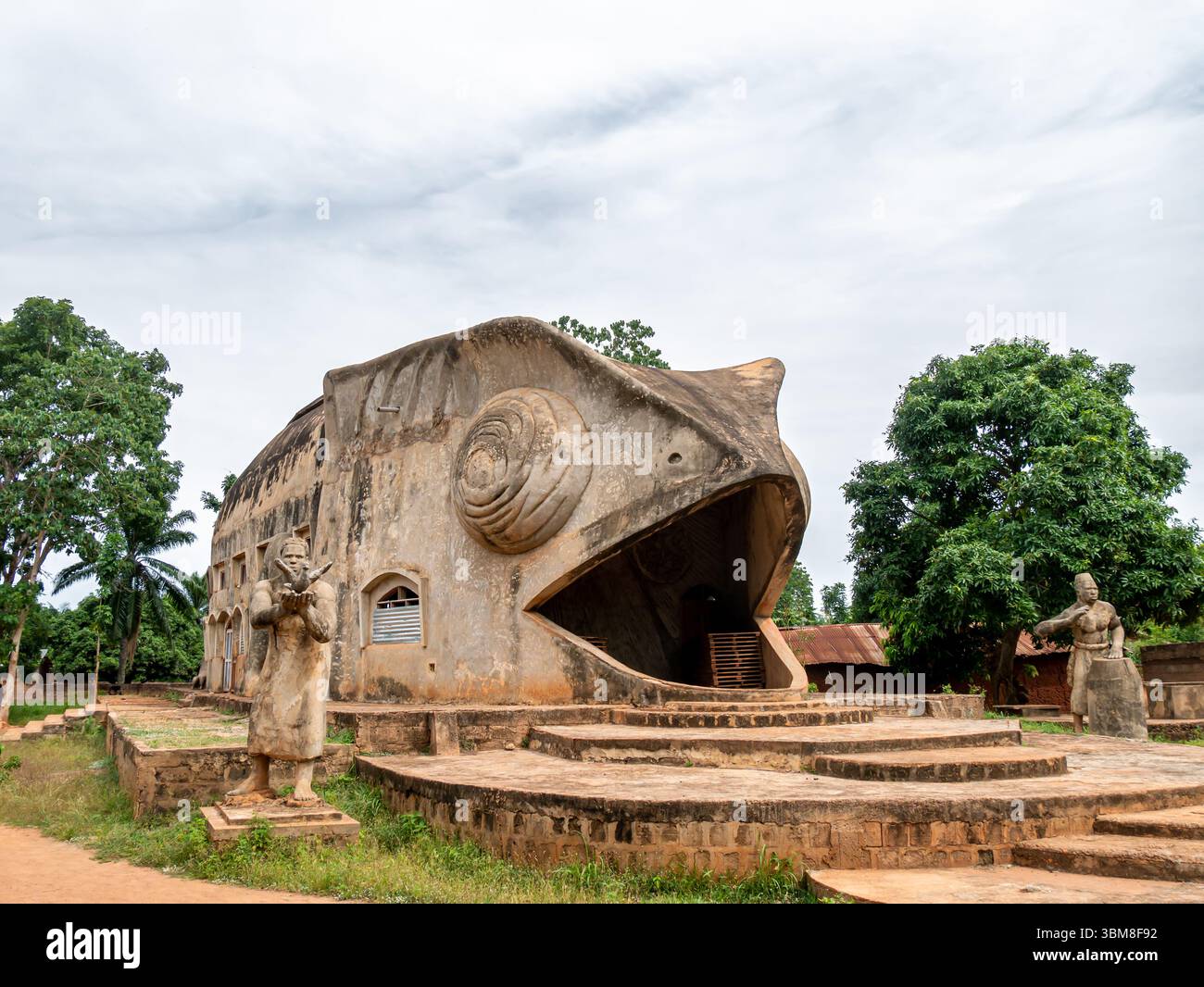 Chameleon-shaped Vodun temple near Abomey, Benin, on a cloudy afternoon ...
