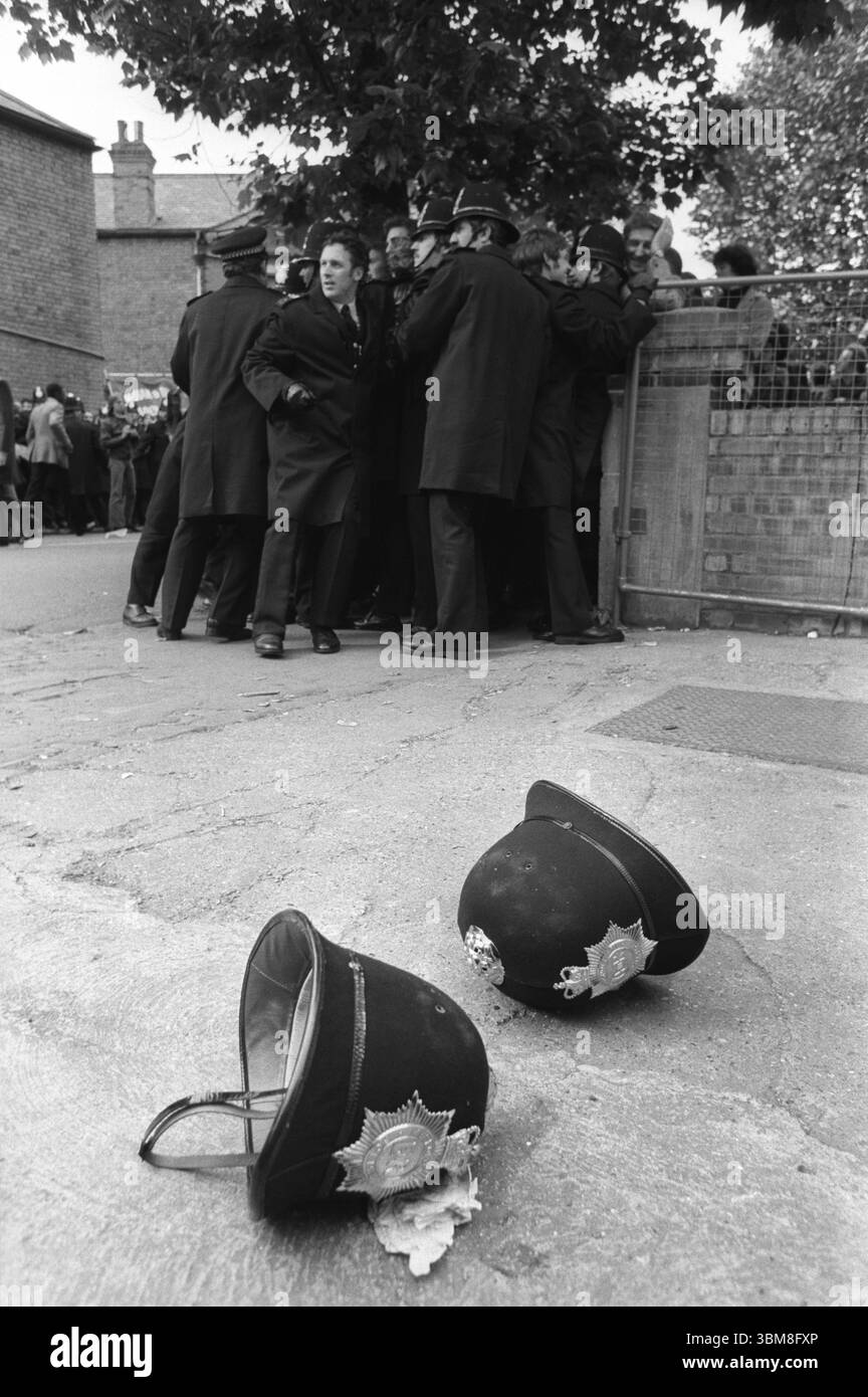 Policemens helmets knocked to the ground during scuffles, violence ...