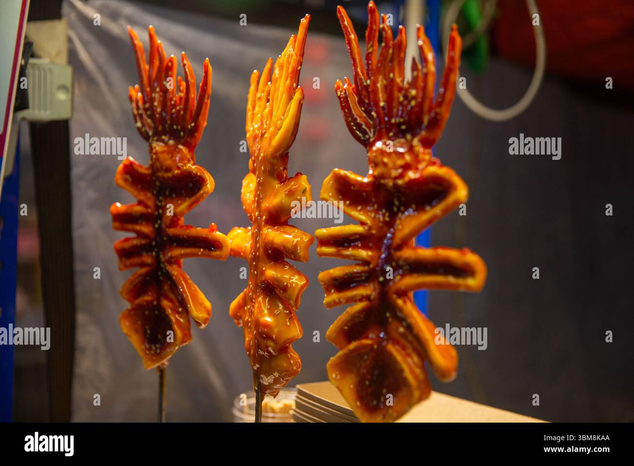 Fried Squid on a Stick in a night market for snacking Stock Photo - Alamy