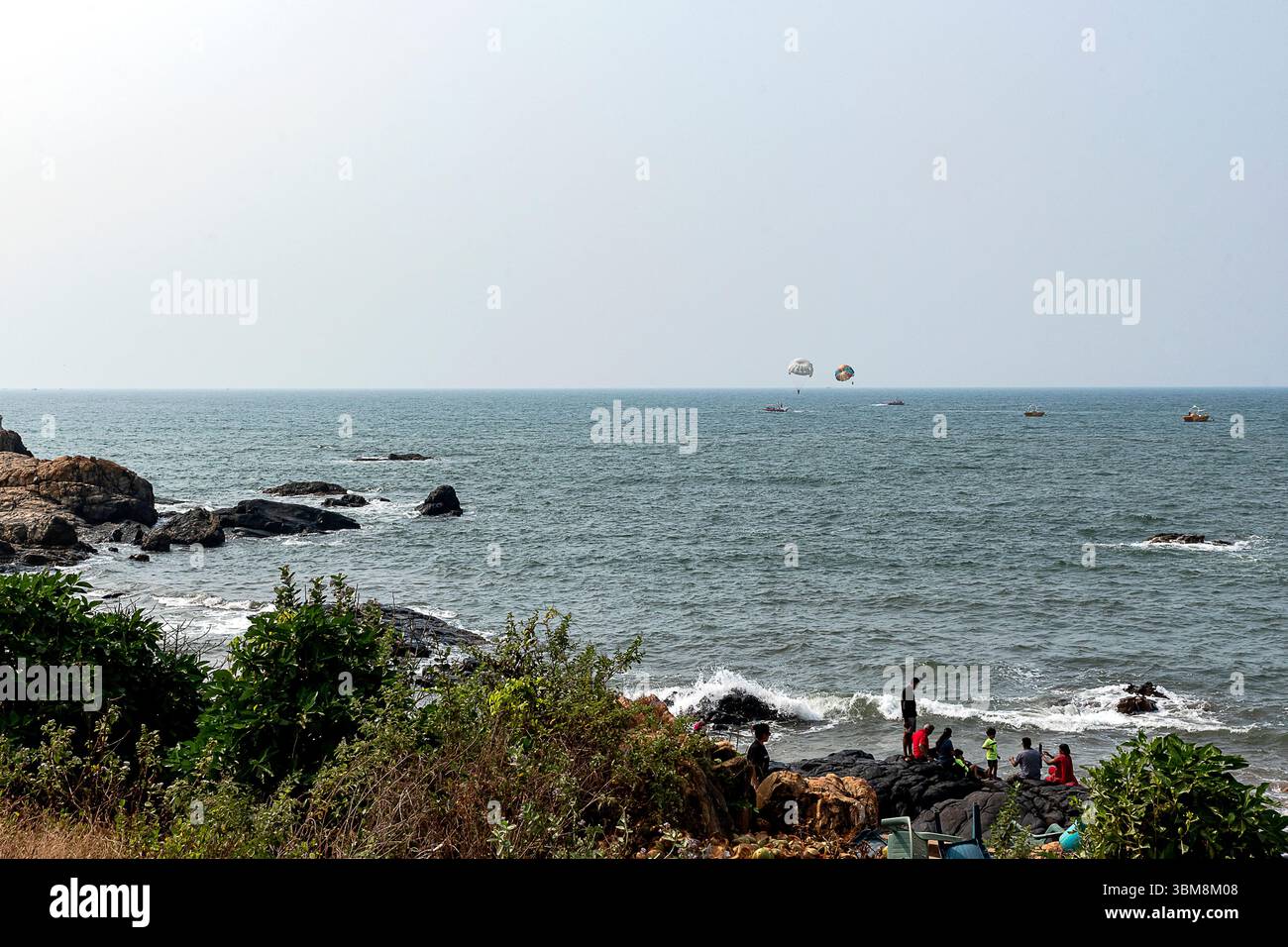 Colorful parasails soar above the sparkling ocean at Vagator Beach in ...