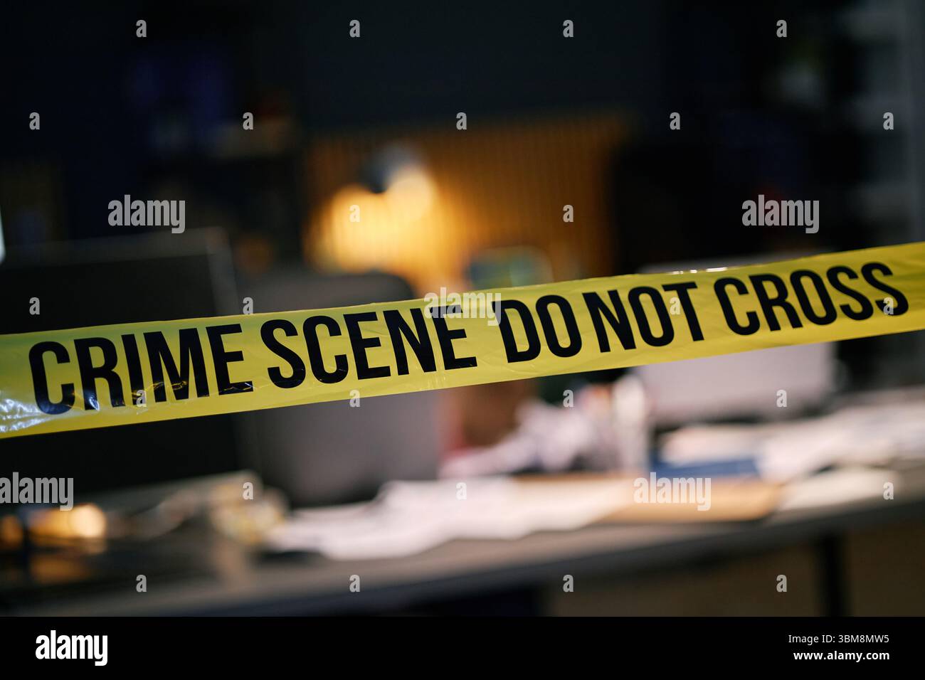 Yellow crime scene tape cordoning off an area inside building with ...
